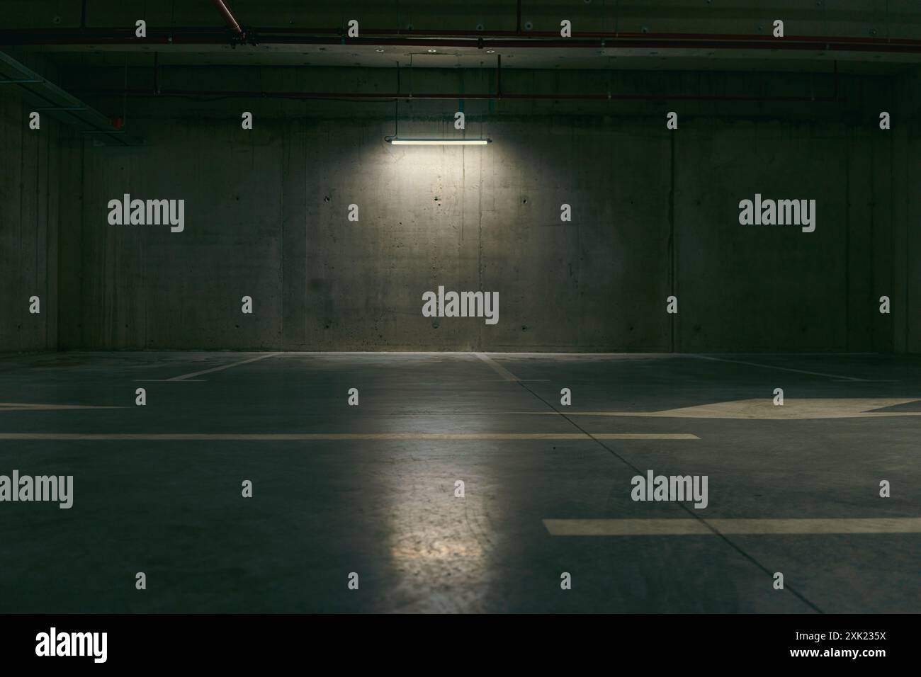 Empty underground garage. Parking lot with overhead dim light Stock ...