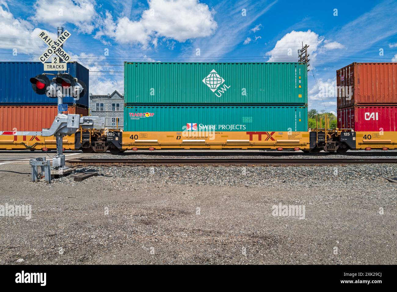 Stacked container cars on a freight train passing over the railroad ...