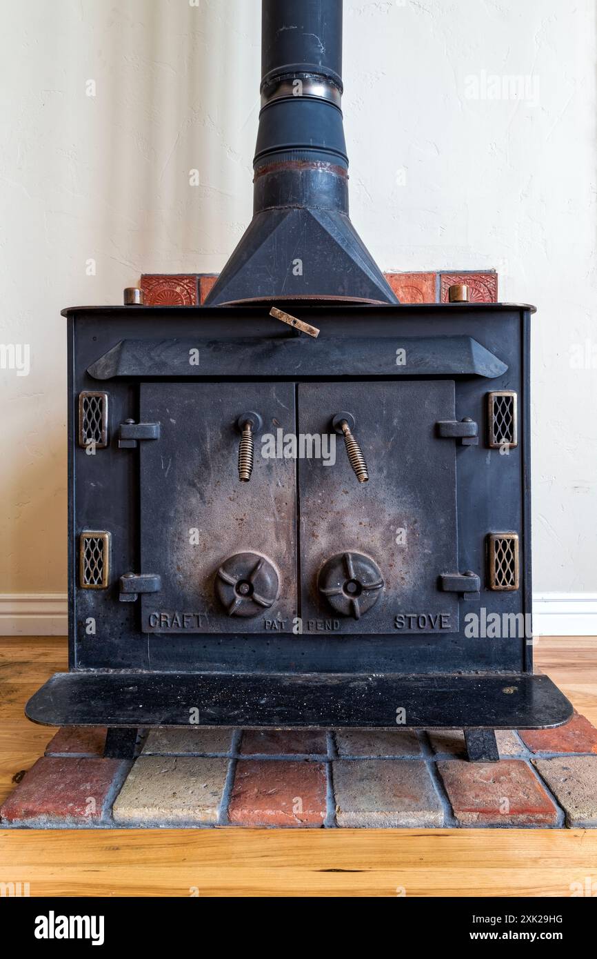 An antique wood burning cast iron Craft Stove installed in a living ...