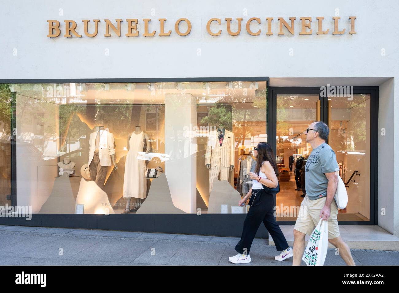Pedestrians walk past the Italian luxury fashion brand Brunello ...