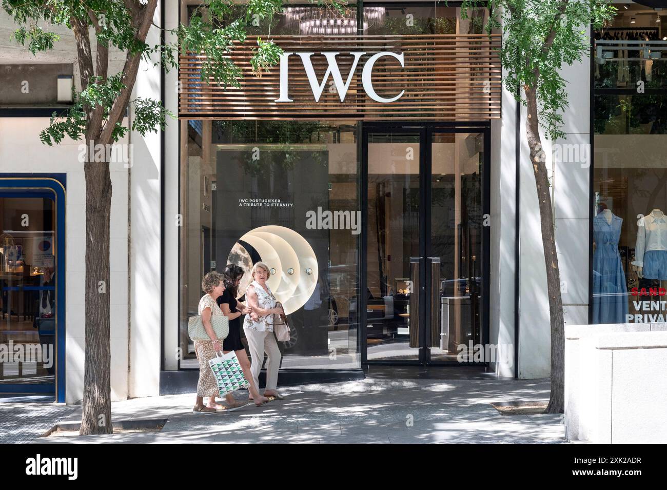 Pedestrians walk past the Swiss luxury watch manufacturer and brand ...