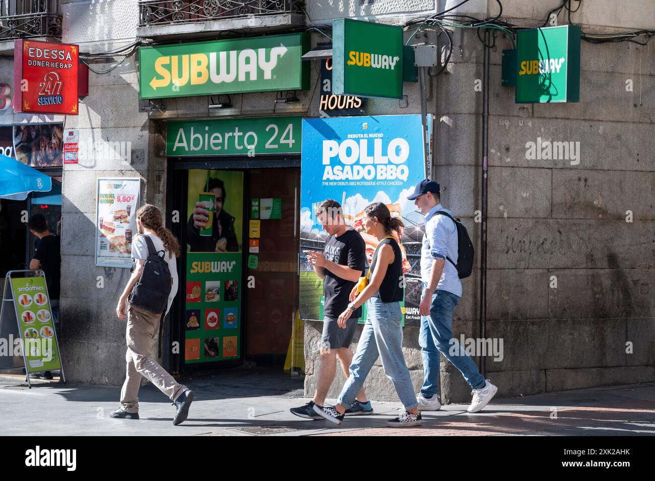 People walk past the American sandwich fast food restaurant franchise ...