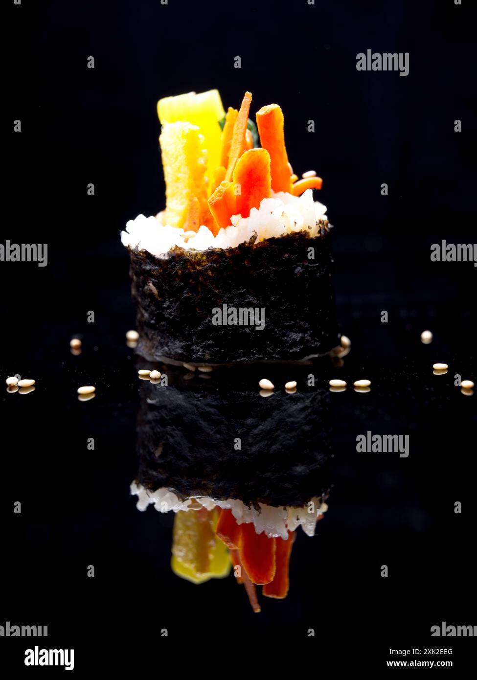 A studio photo of a slice of Korean kimbap showing a mirror like ...