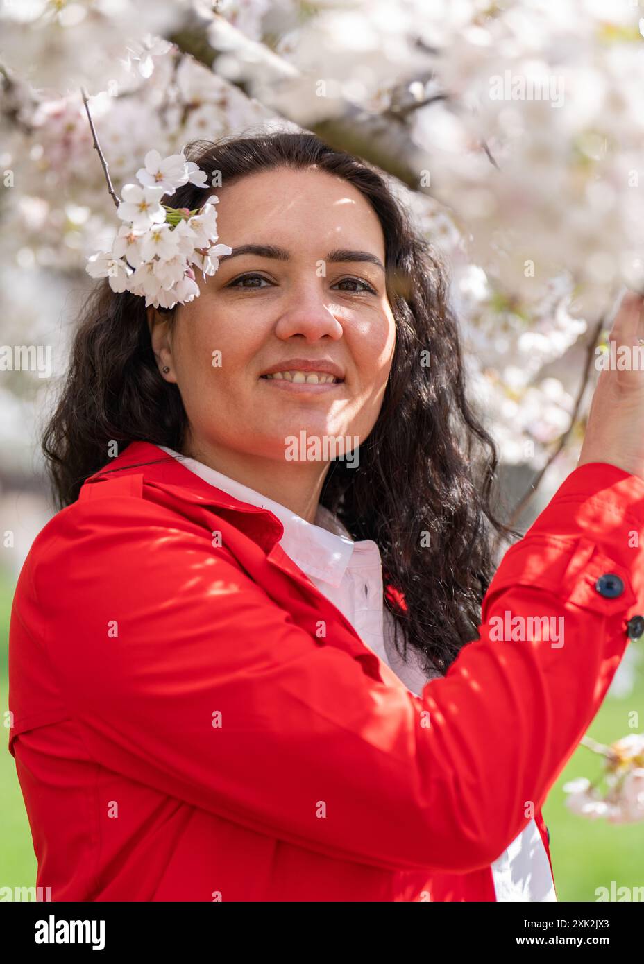 romantic image of a stylish woman in a red coat and white blouse ...
