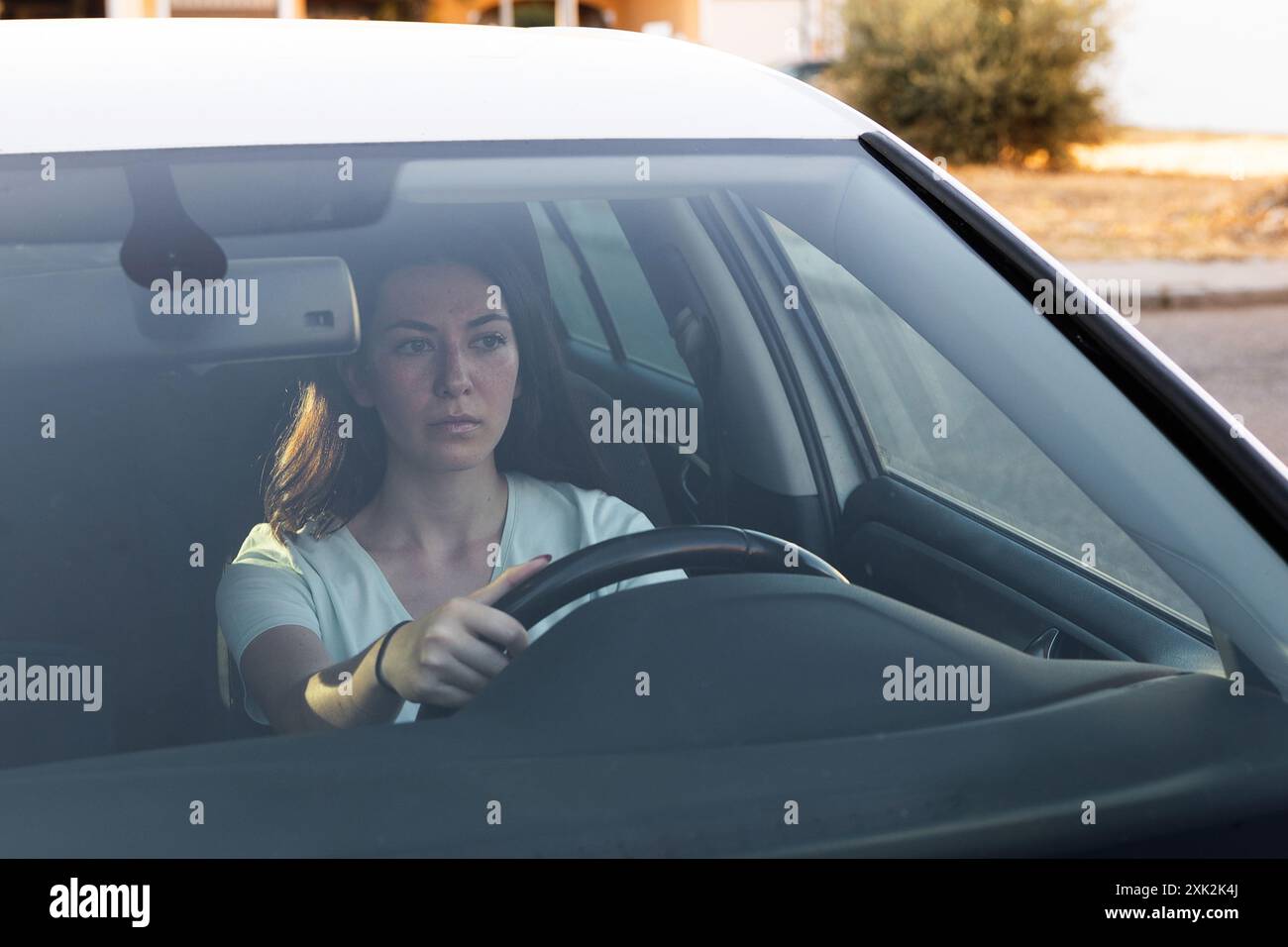 Woman driving car focused expression hi-res stock photography and ...