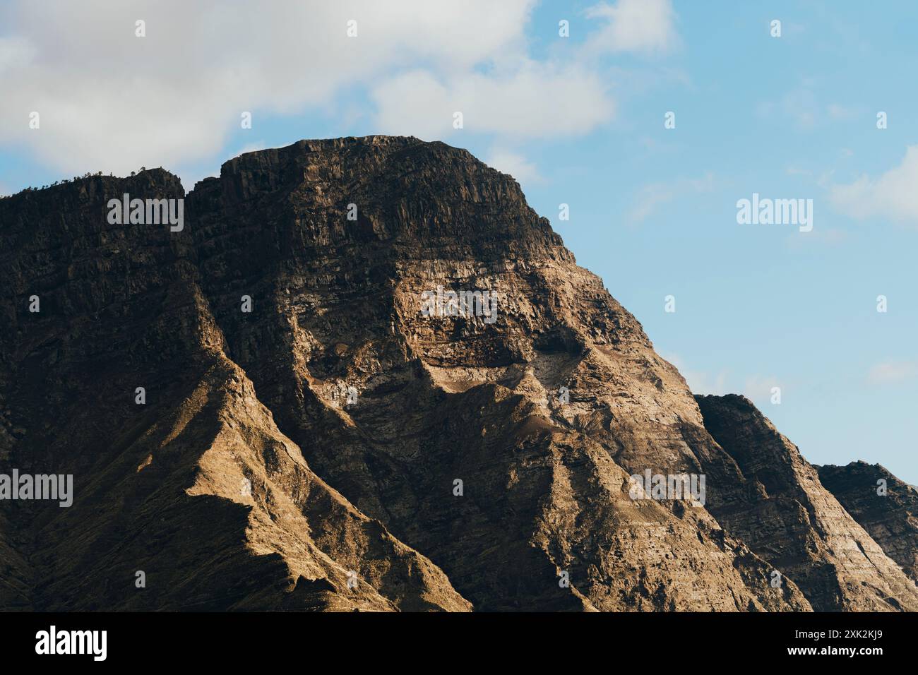 A breathtaking view of a towering mountain under a clear blue sky ...