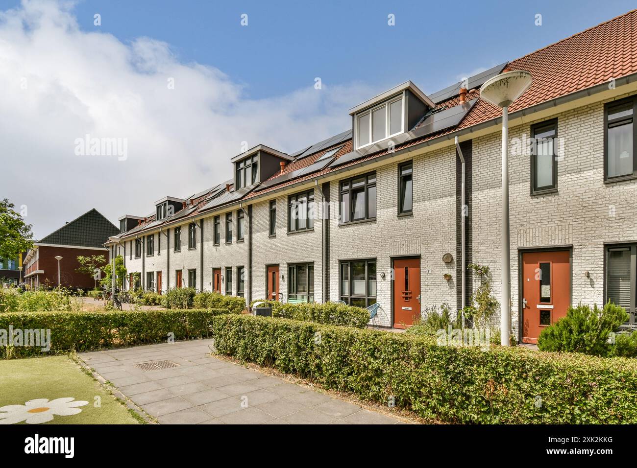 Row of modern townhouses with brick facades and colorful doors ...