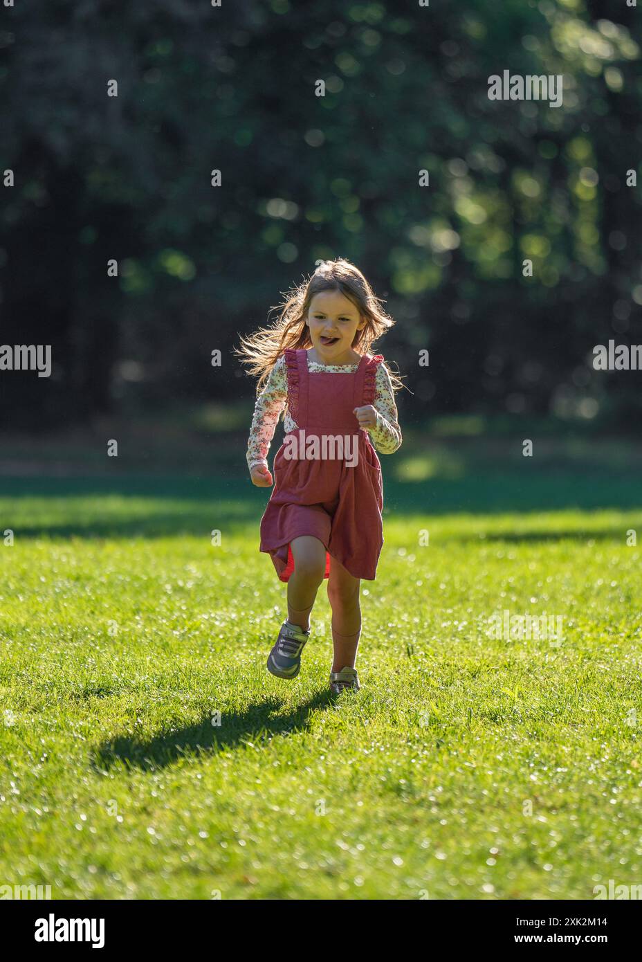 A small, cute girl runs quickly. Walk in the park. Active lifestyle ...