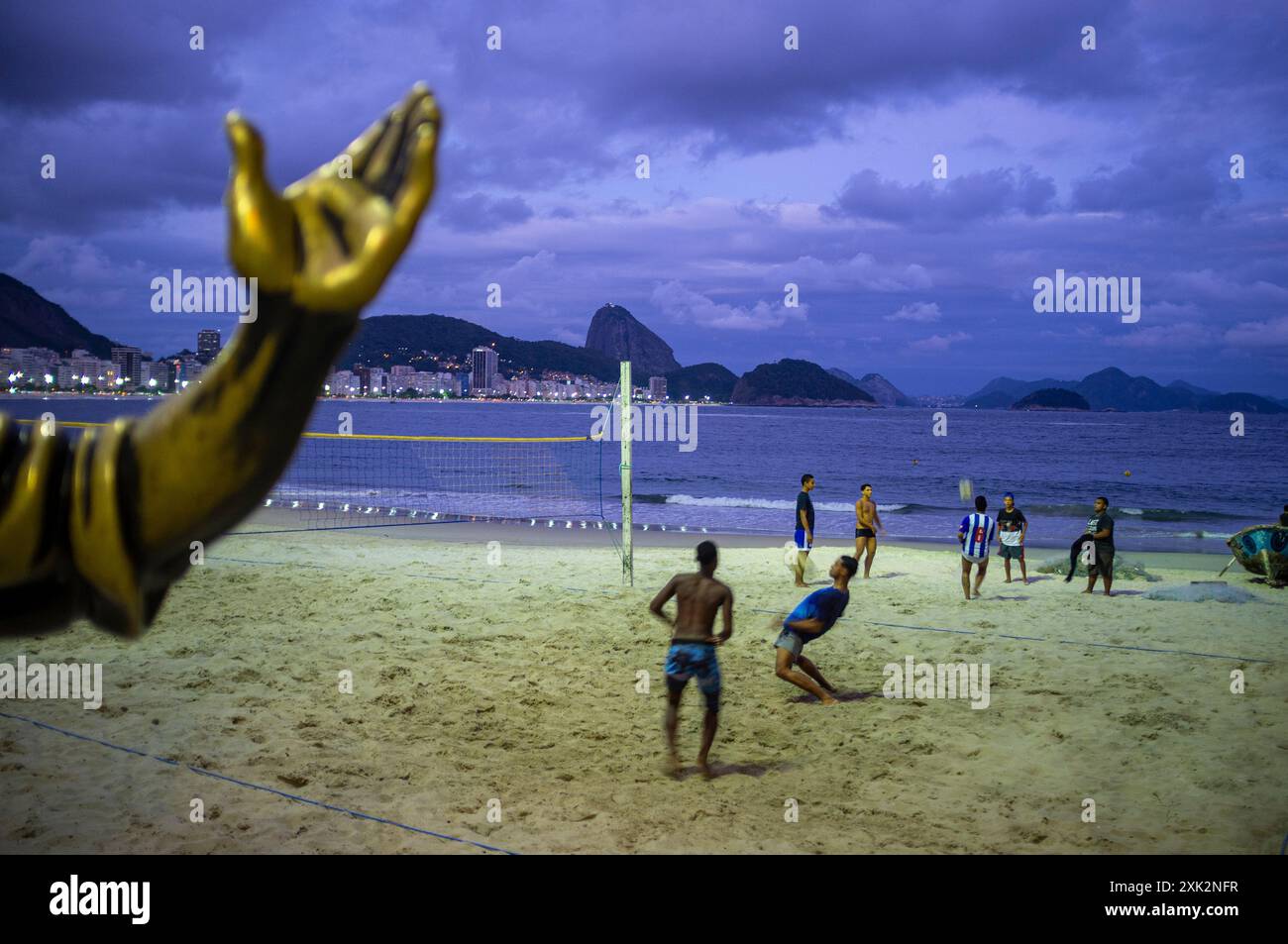 Beach culture at Copacabana beach - boys play footvolley in the middle ...