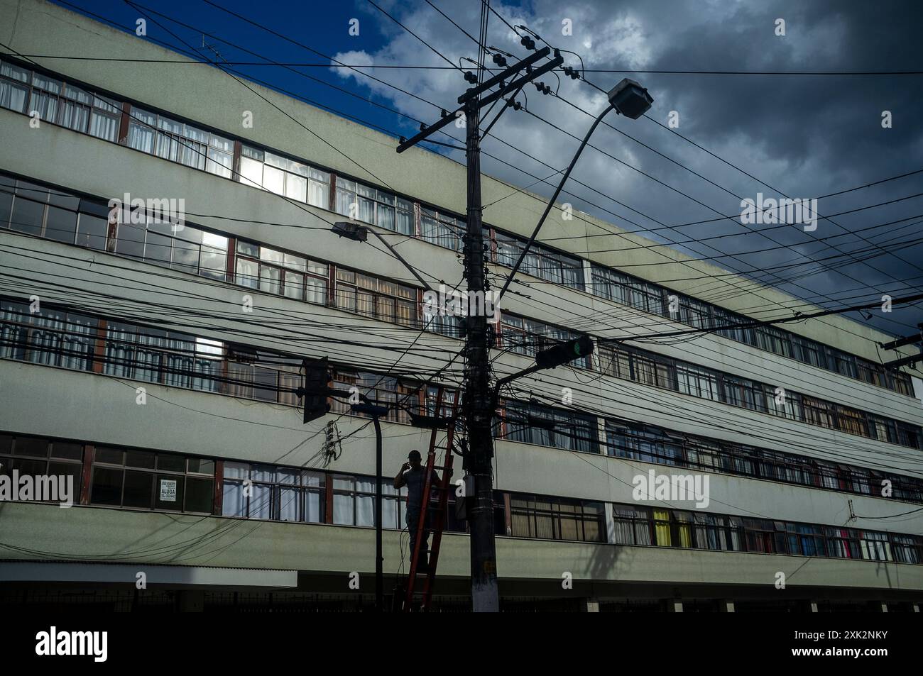 Worker of the electricity distribution company using a cell phone on ...