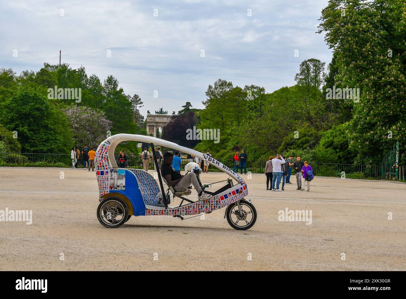A modern three-wheeled rickshaw waiting for passengers in the Sempione ...