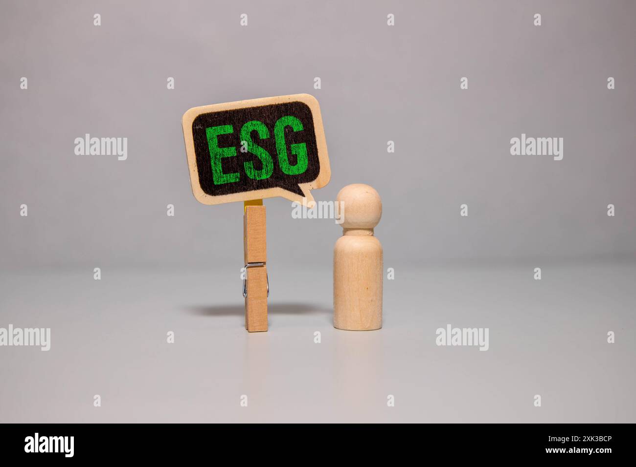 Planet earth inside of glass bottle and ESG text on round wooden blocks ...