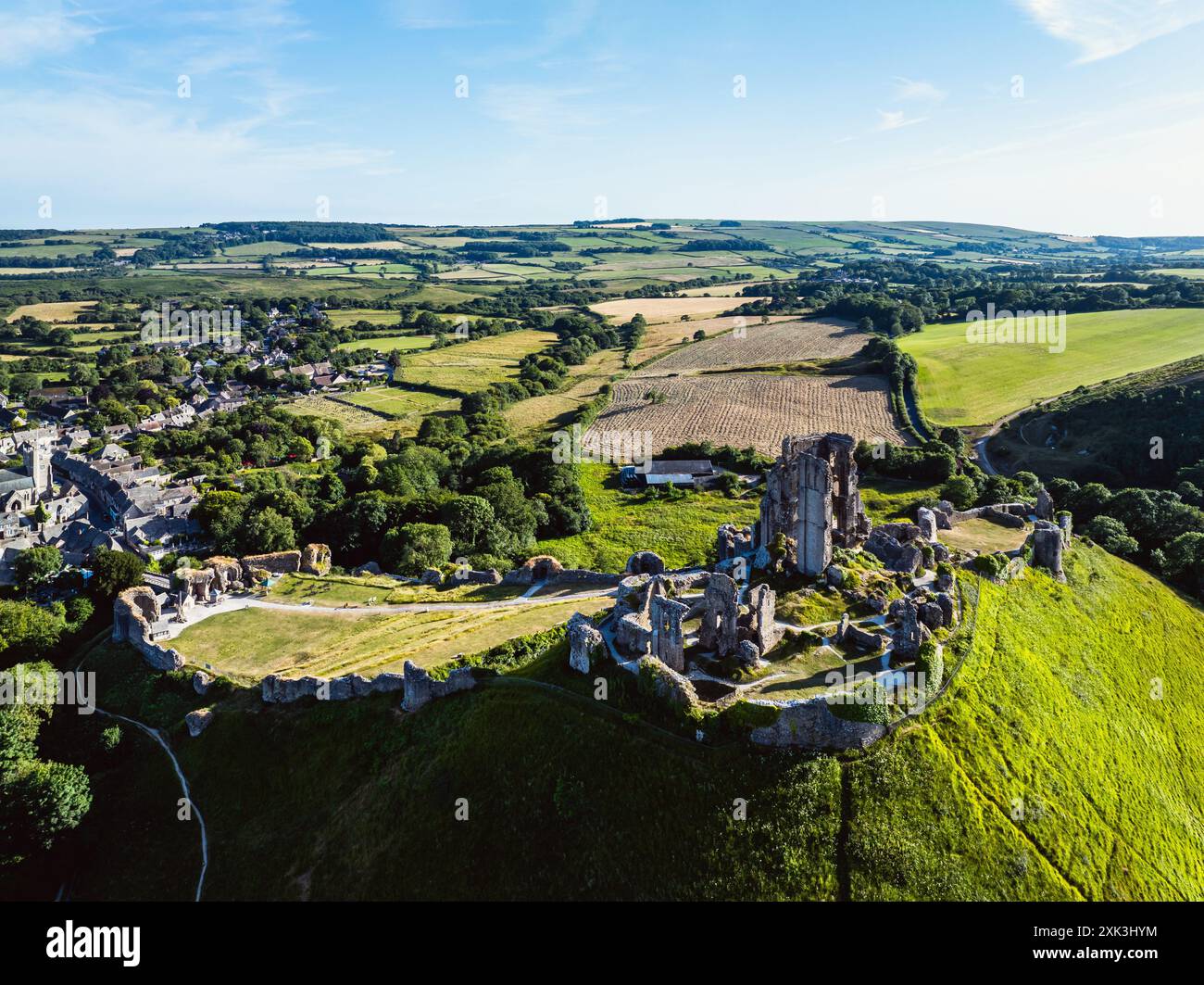 Ruins of Corfe Castle from a drone, Corfe Village, Purbeck Hills ...