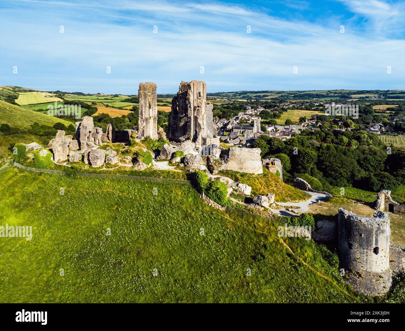 Ruins of Corfe Castle from a drone, Corfe Village, Purbeck Hills ...