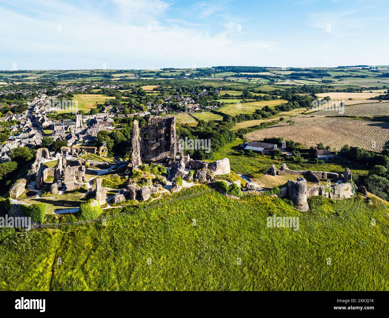 Ruins of Corfe Castle from a drone, Corfe Village, Purbeck Hills ...