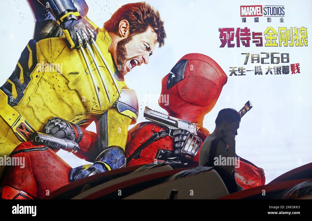 SHANGHAI, CHINA -JULY 19, 2024 - Fans walk past movie posters at Wanda Studios in Shanghai ...