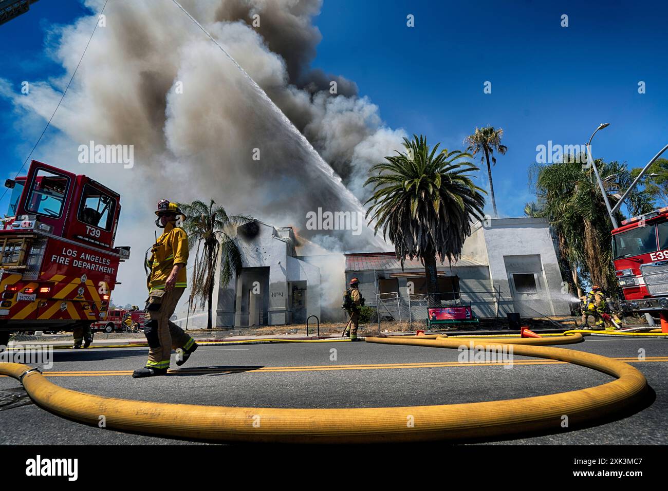 Los Angeles Fire Department firefighters battle a blaze in a vacant single-story commercial ...