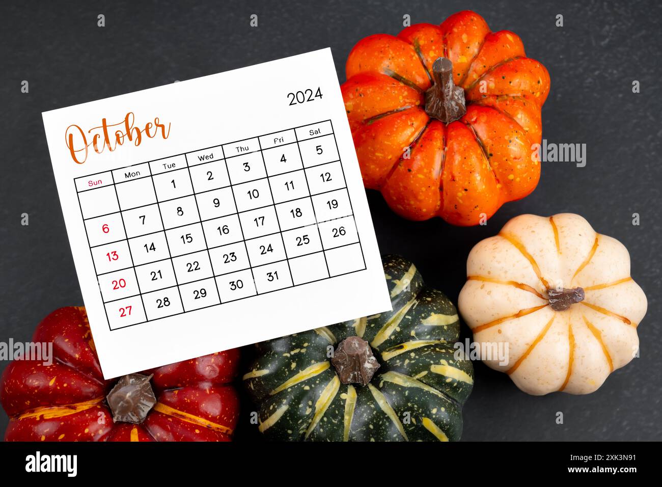 2024 October calendar sheet and pumpkins on black color background ...