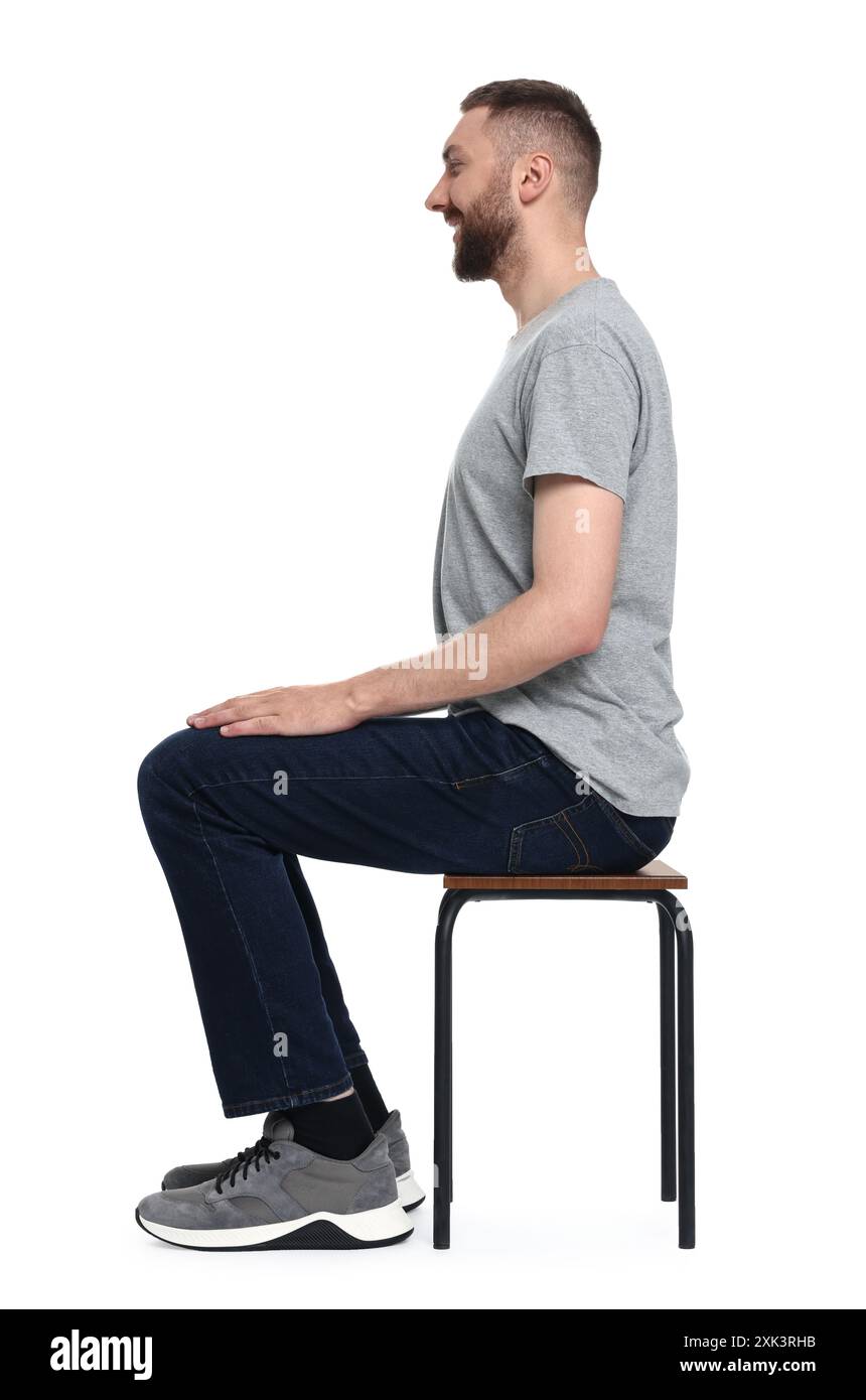 Man with good posture sitting on chair against white background Stock ...