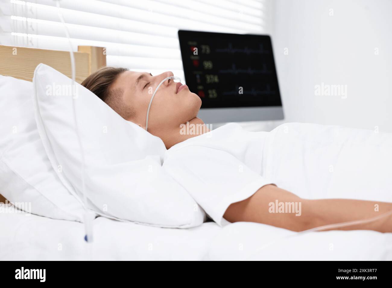 Coma patient. Young man sleeping in hospital bed Stock Photo - Alamy