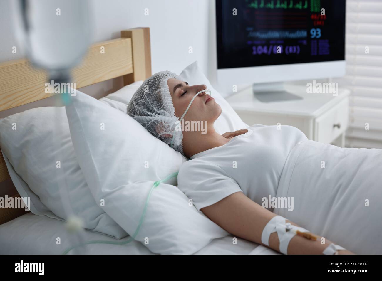 Coma patient. Young woman with intravenous drip in hospital bed Stock ...