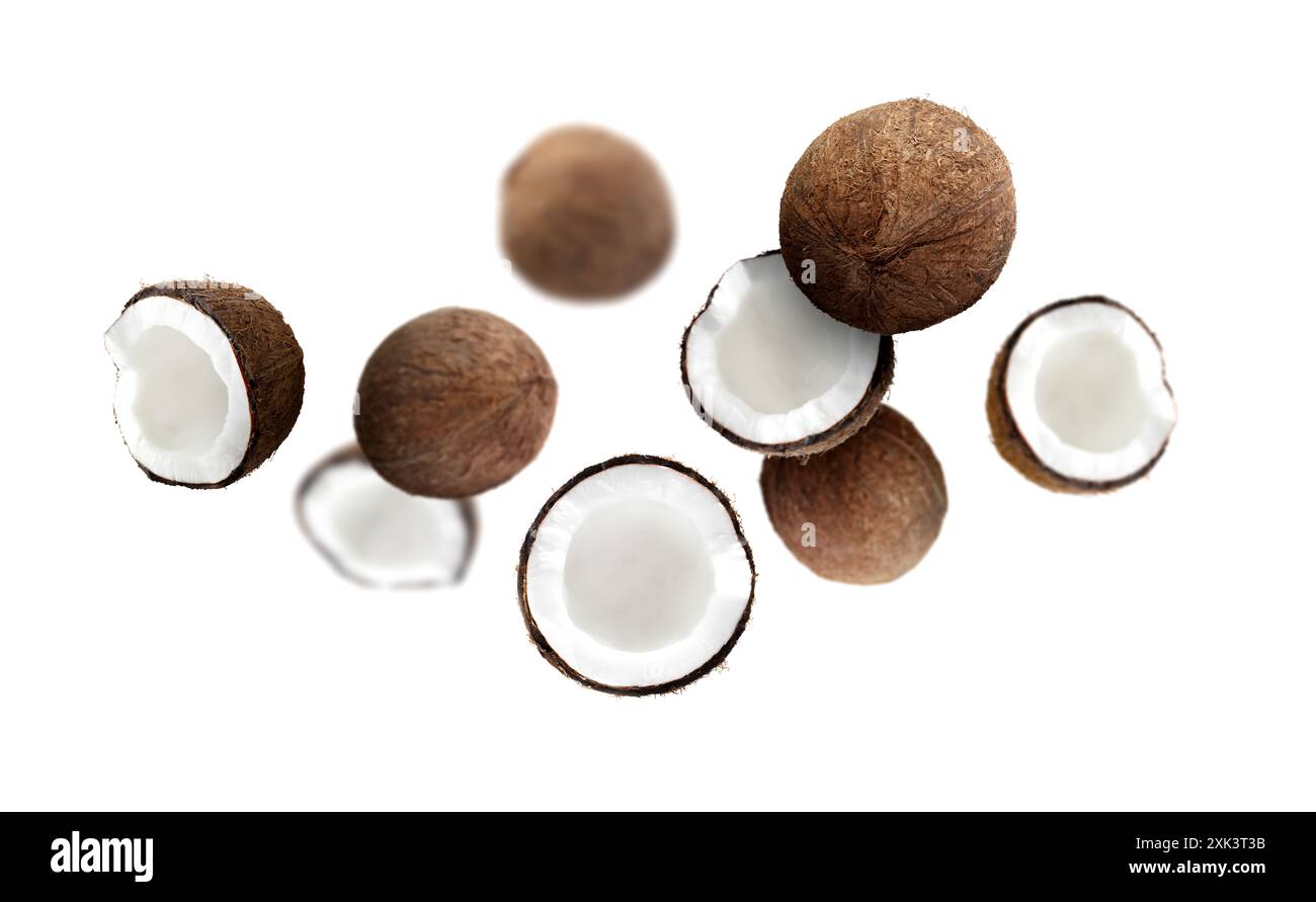 Many coconuts in air on white background Stock Photo - Alamy