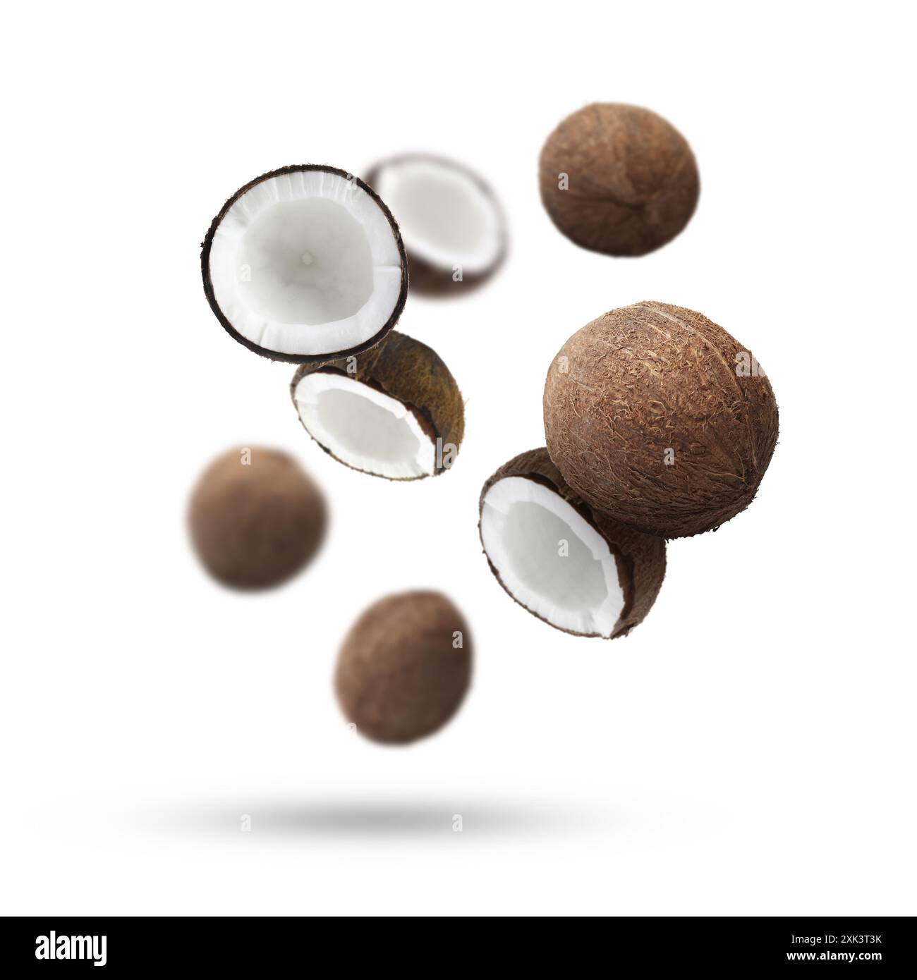 Many coconuts in air on white background Stock Photo - Alamy