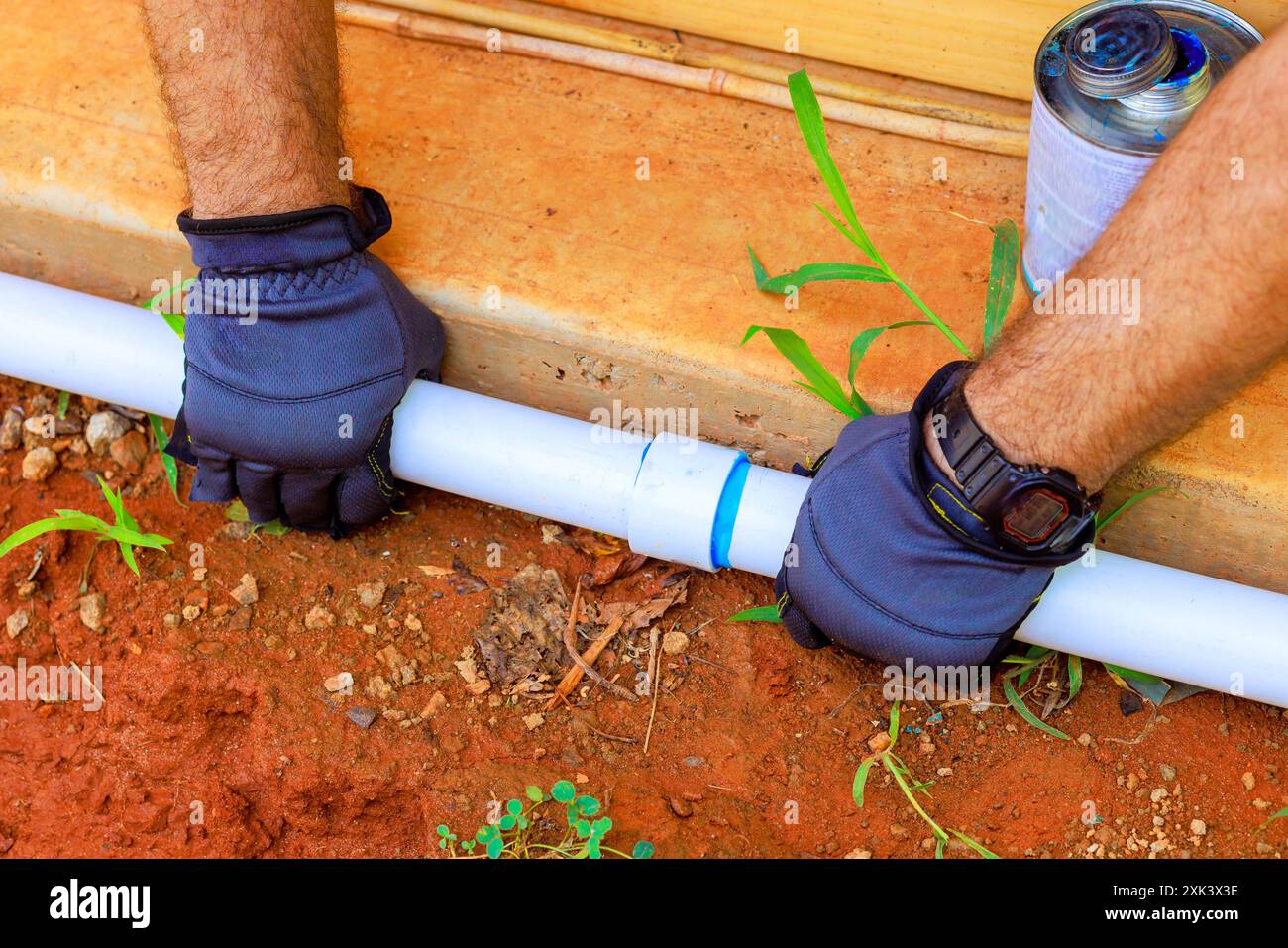 Glues plastic PVC pipes for laying water supply Stock Photo - Alamy