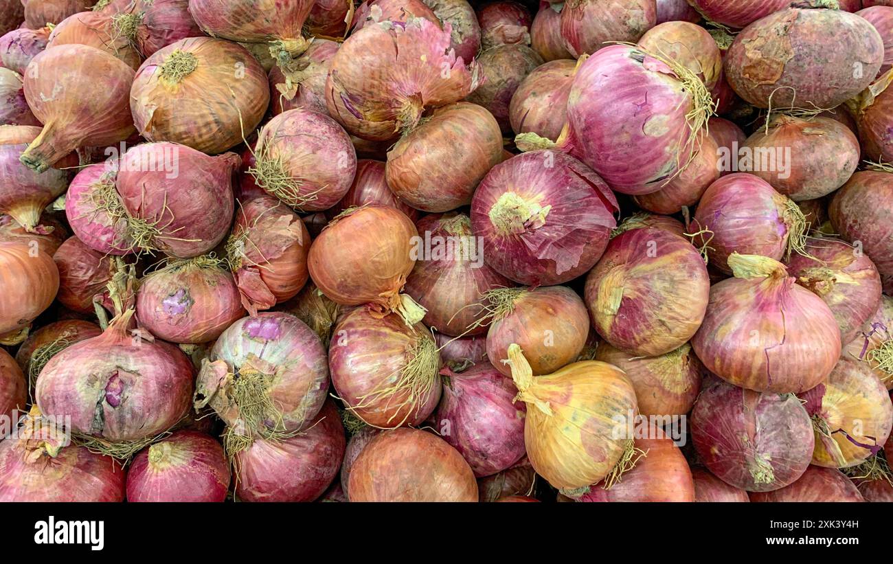 Top view of red onions displayed in supermarket. Healthy food concept ...