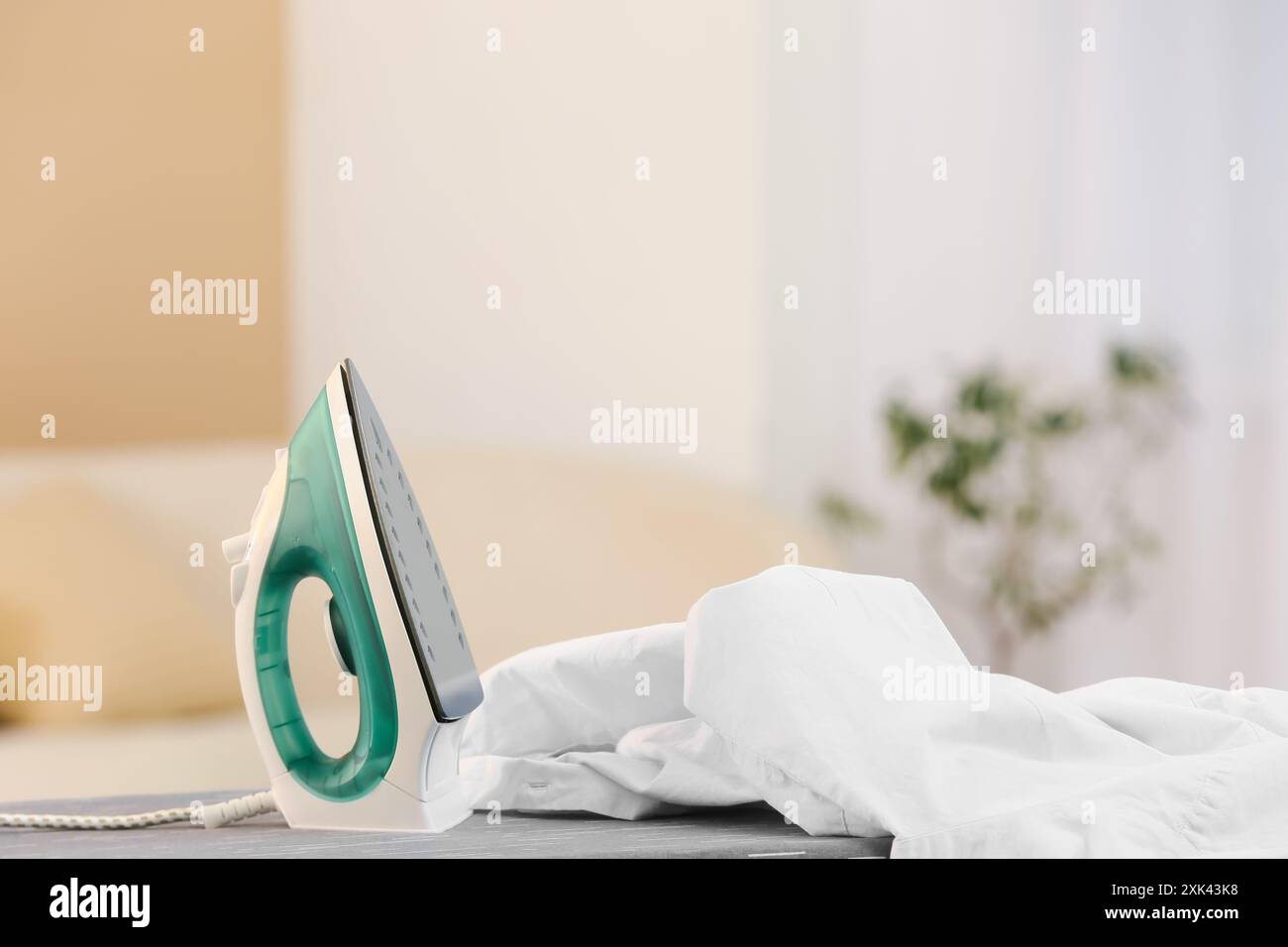 Iron and clean clothes on board Stock Photo - Alamy