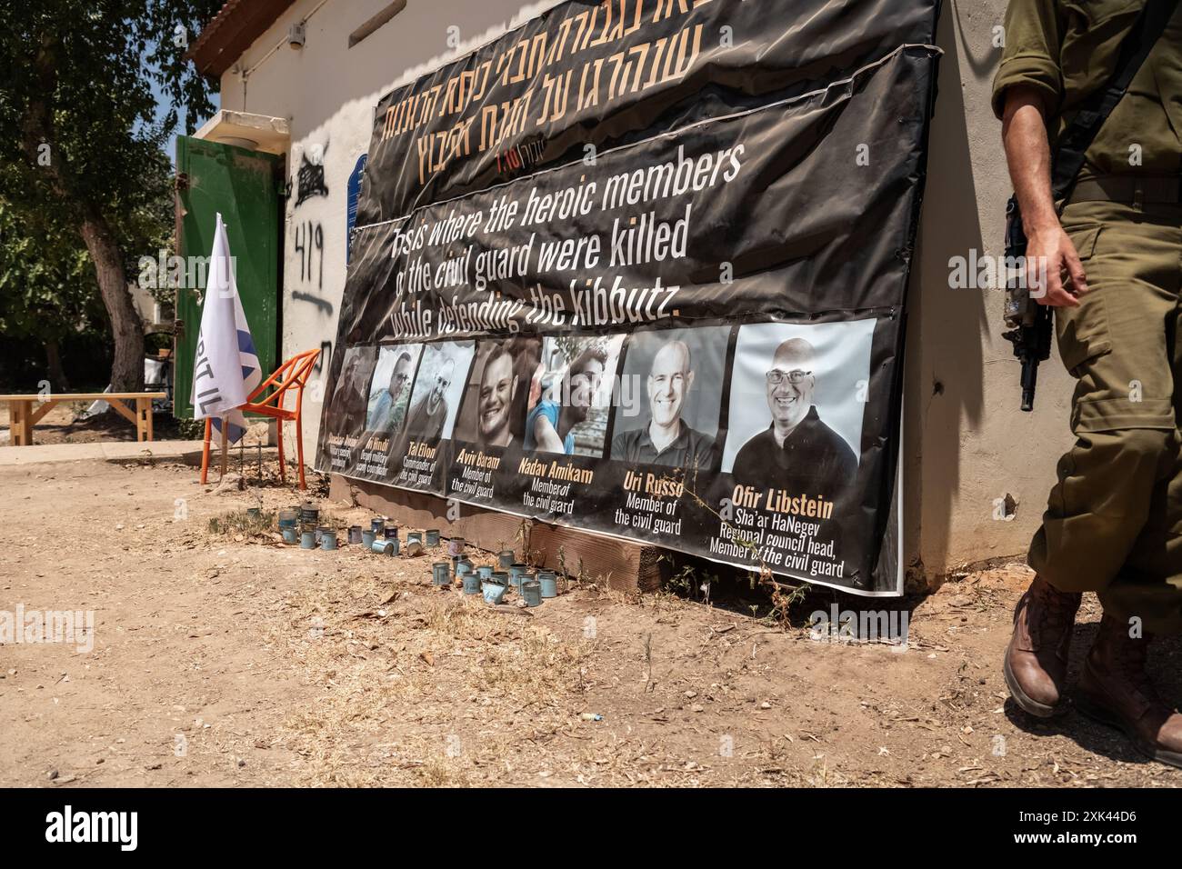 July 18, 2024, Kfar Aza, Israel: A local soldier walks past the local ...
