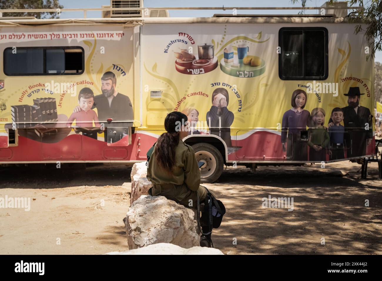 Israeli soldiers rest in the beck of a Yeshiva van parked in the area ...
