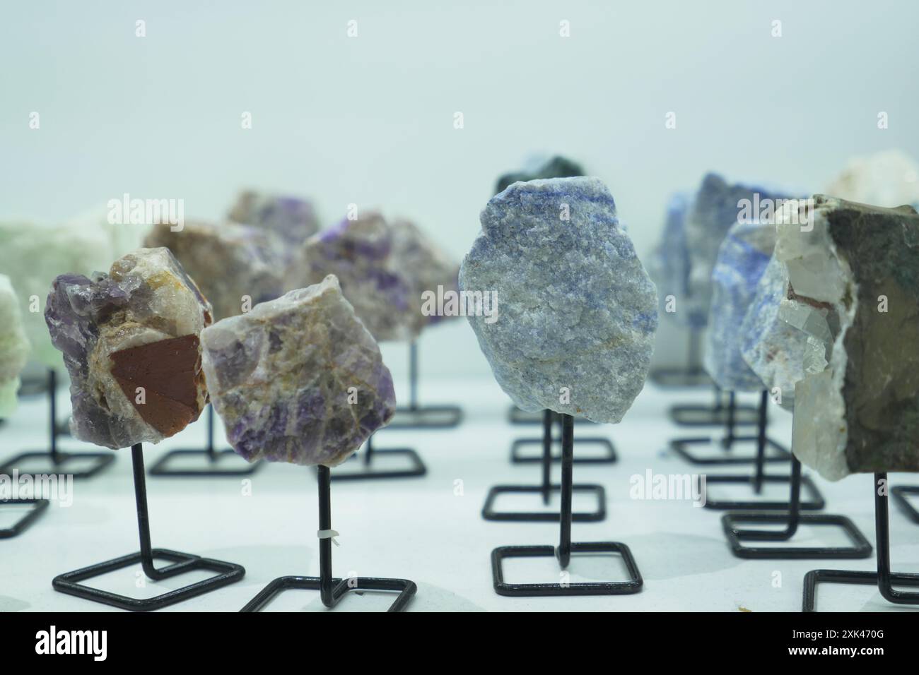 Various rocks are showcased on a table for art display Stock Photo - Alamy