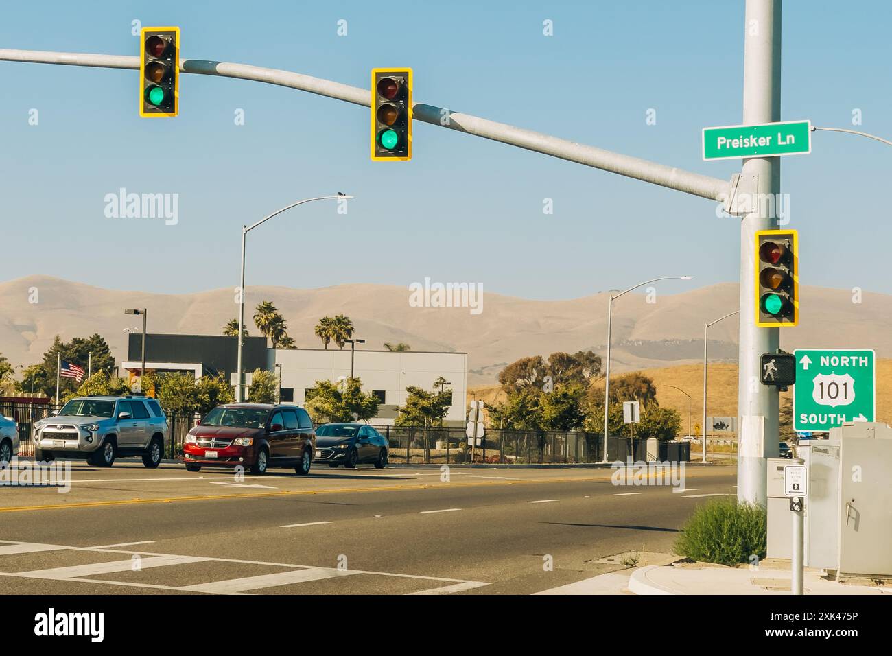 Santa Maria, California, USA - July 20, 2024. Cars wait at a red light ...