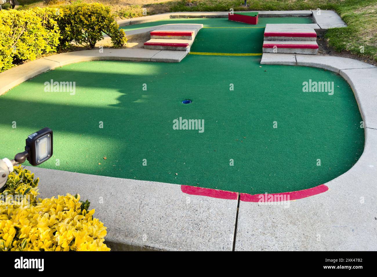 Colorful mini-golf course features various holes and playful challenges ...