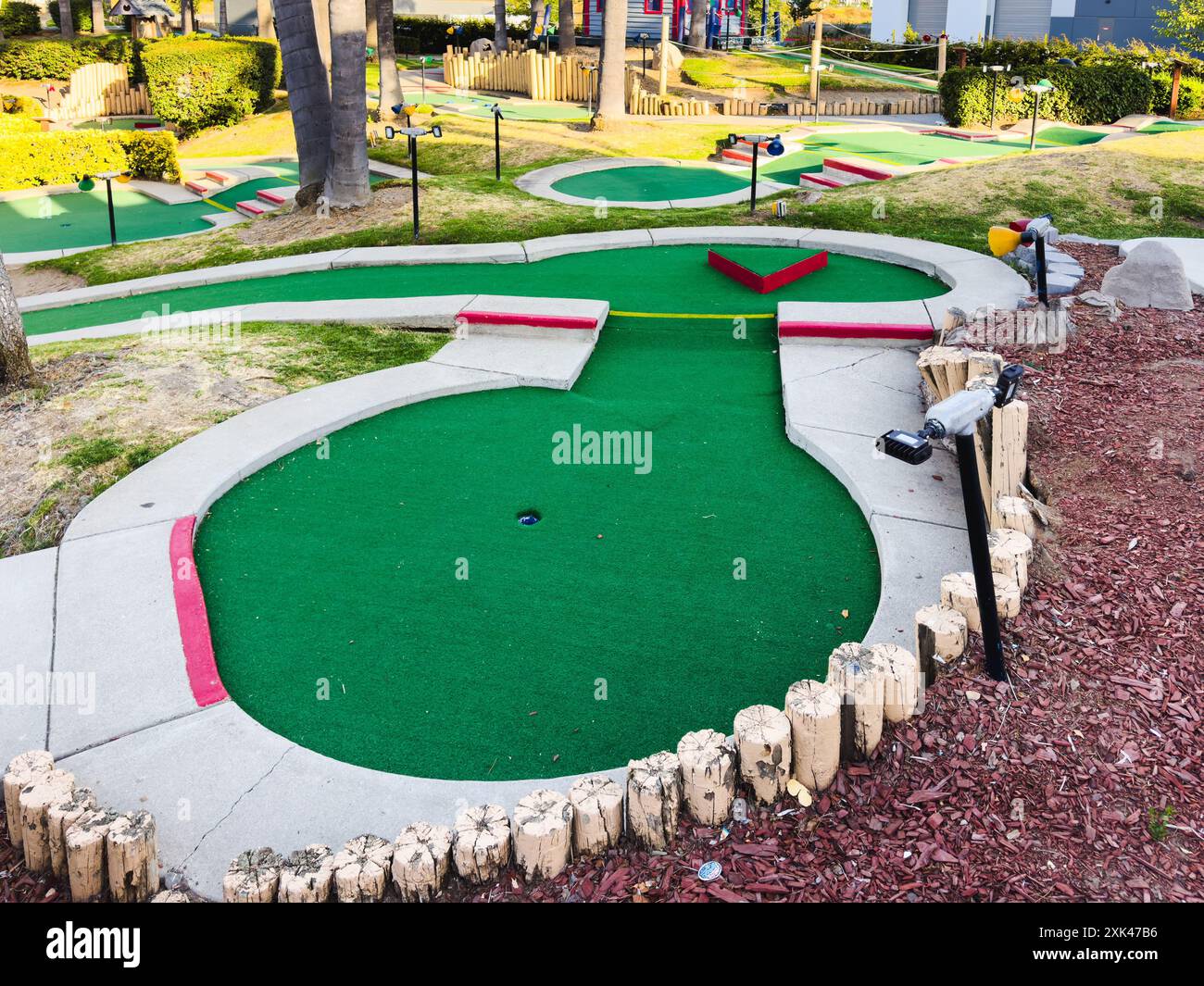 Colorful mini-golf course features various holes and playful challenges ...
