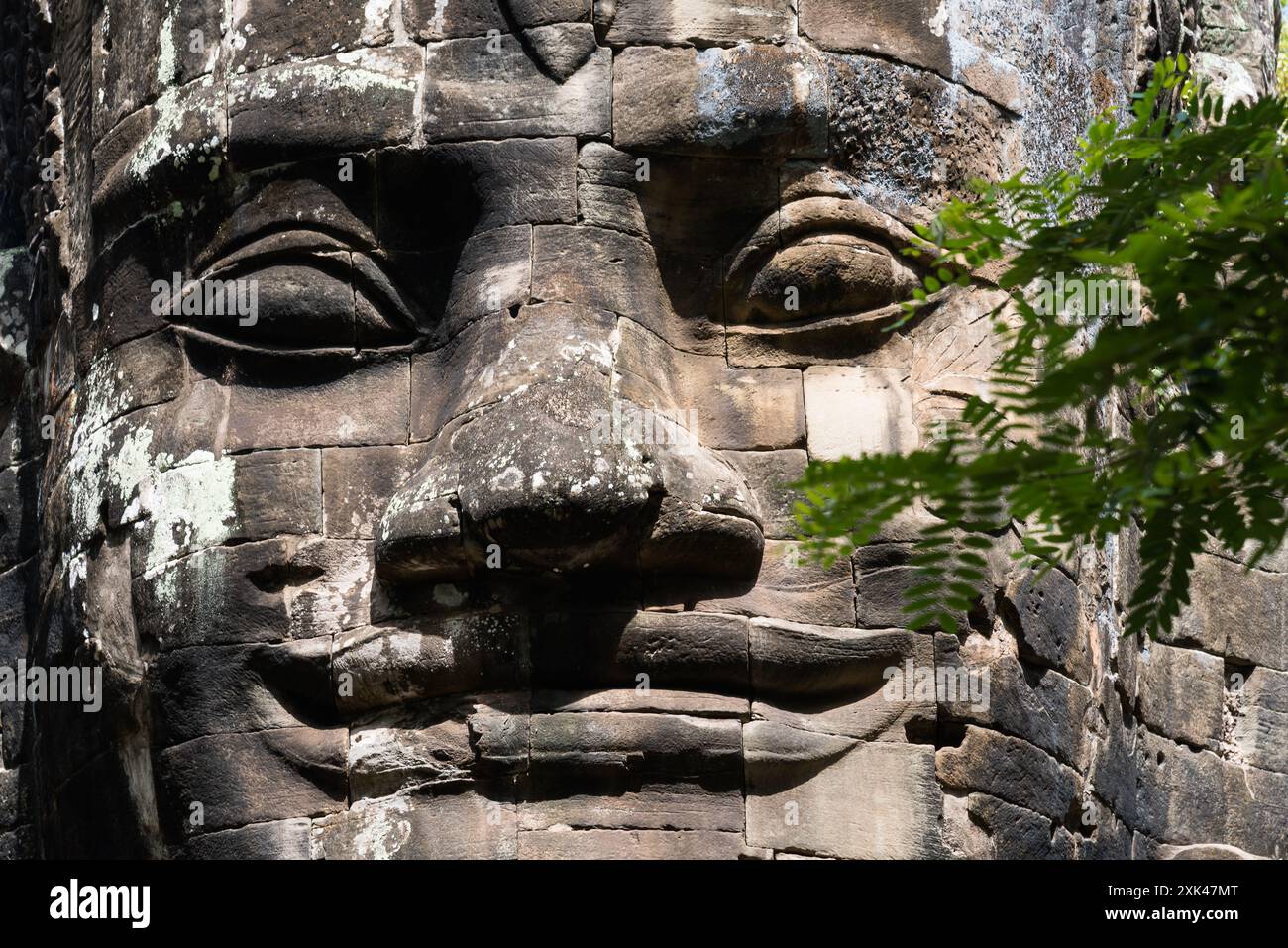A closeup of huge head sculpture at the historic temple complex of ...
