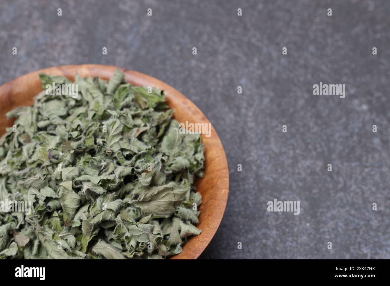 Dry oregano leaf herb in brown wooden bowl Stock Photo - Alamy