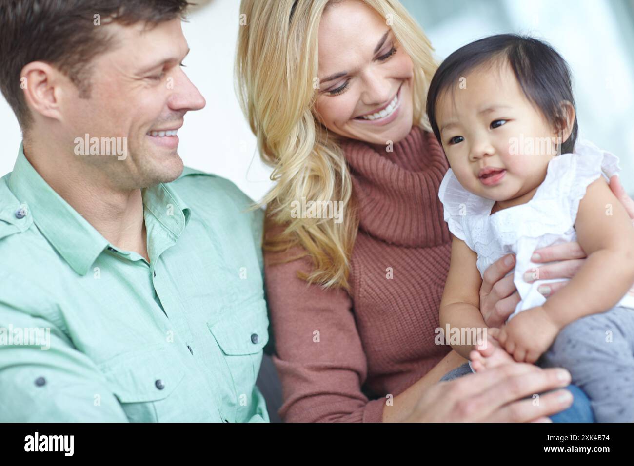 Happy family, parents and adopted baby in home for custody, support and ...
