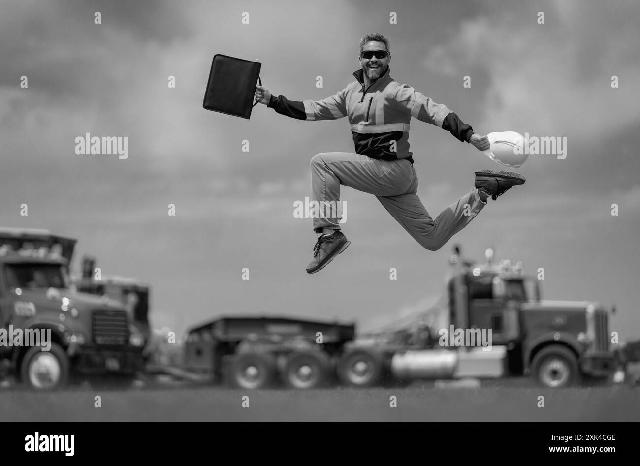 Middle aged builder excited jump on site construction. Excited builder ...