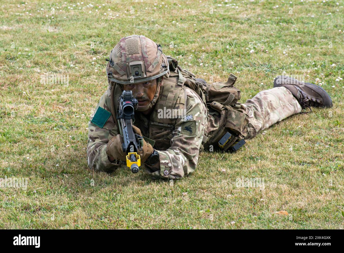 COLCHESTER ENGLAND June 29 2024: Assault Rifleman lying prone pointing ...