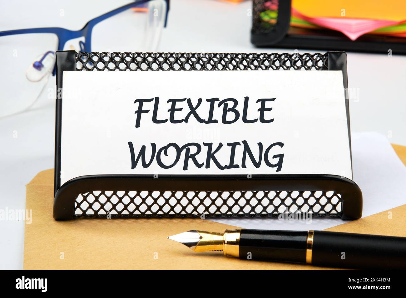 FLEXIBLE WORKING text on a business card in a black stand Stock Photo ...
