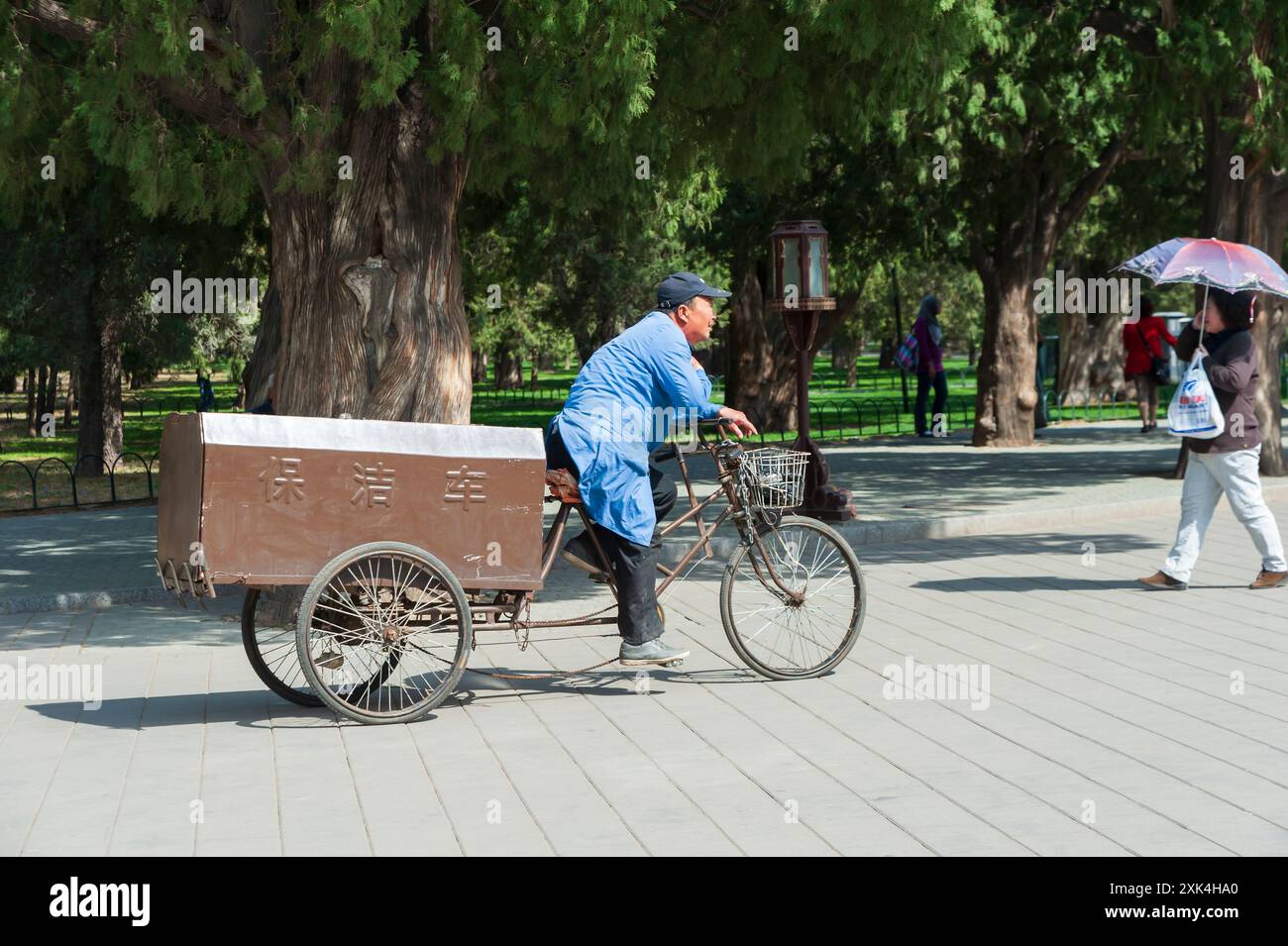 China, Beijing, April 13th, 2012. Chinese man riding a cargo tricycle ...
