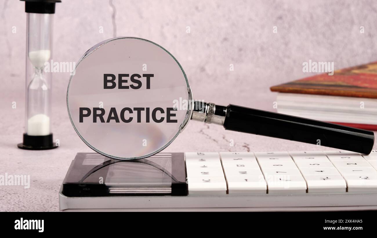 BEST PRACTICES text written through a magnifying glass on a gray wall ...
