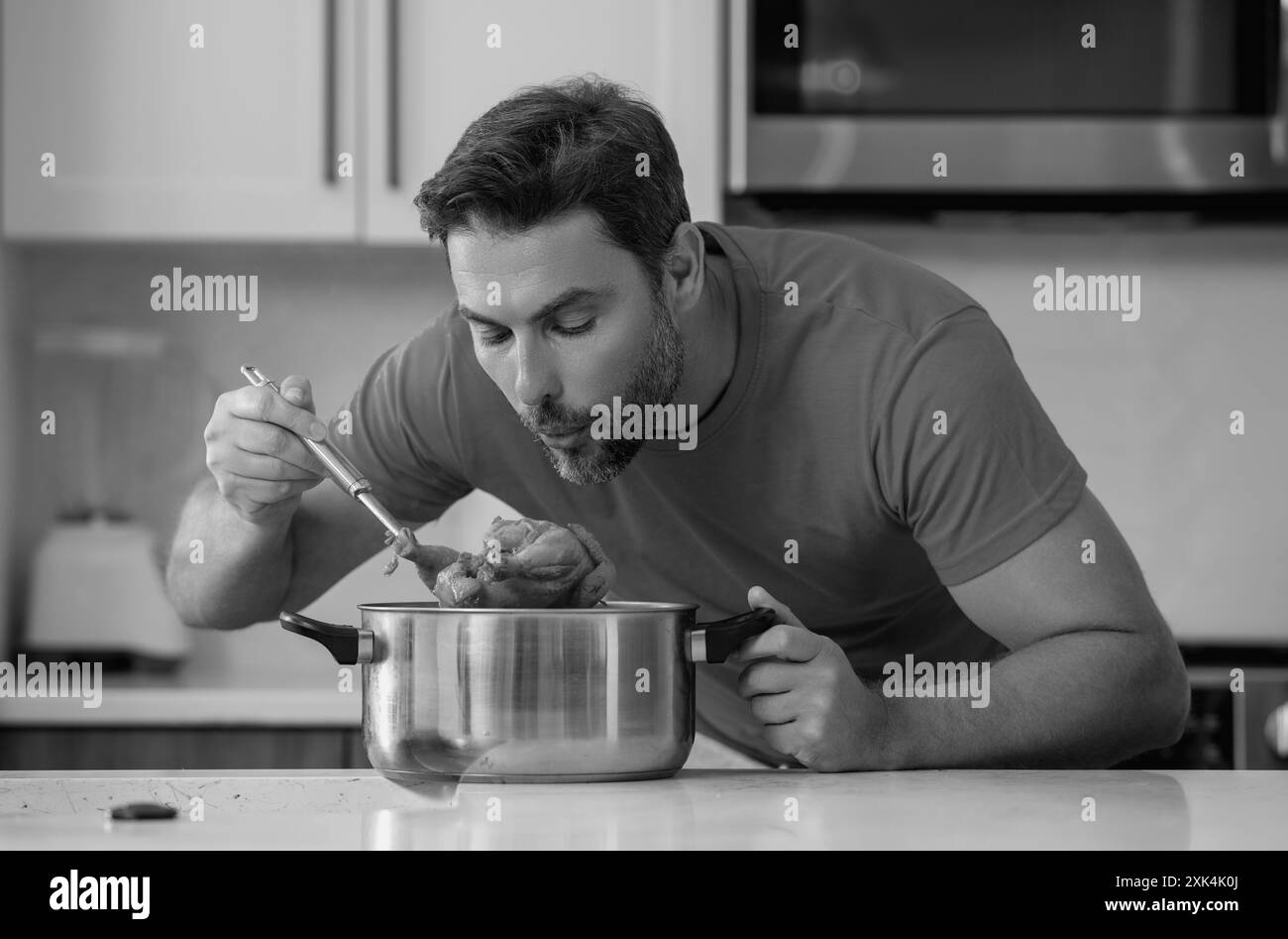 Male cook or chef cooking food in pan pot in kitchen. Process of ...