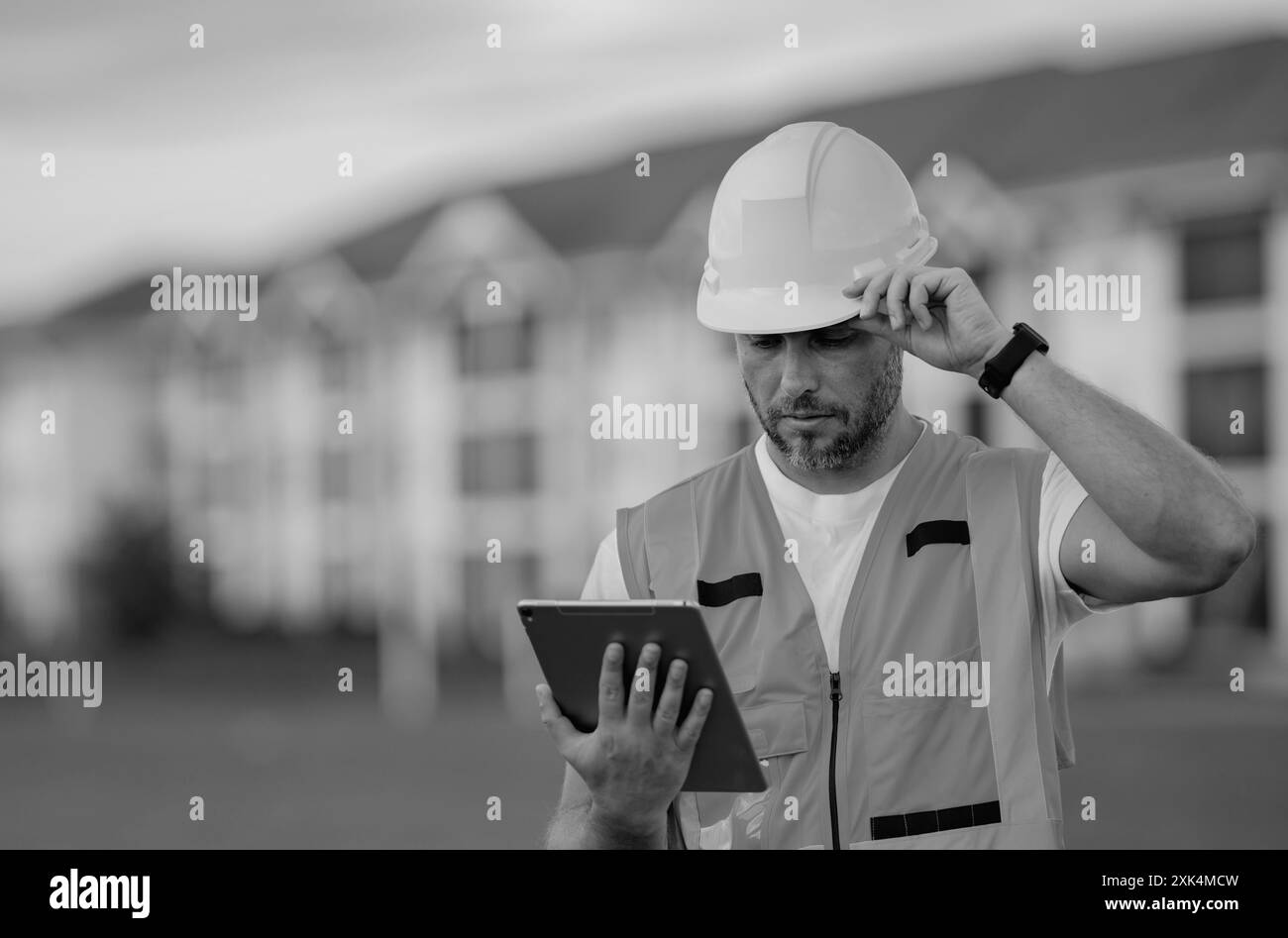 Engineer with tablet, building inspection. Construction man in helmet ...