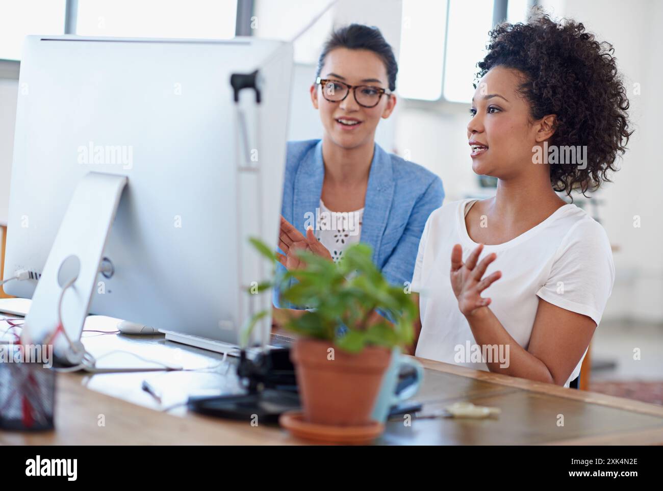 Women, coworker and computer in office for brainstorming, project or ...