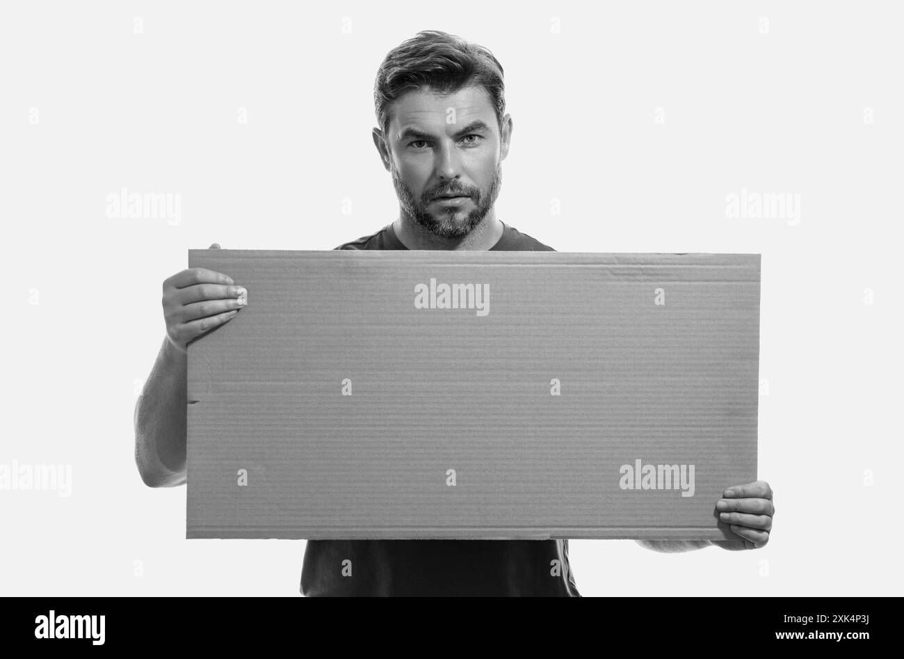 Handsome man holding empty board isolated on studio background. Guy ...