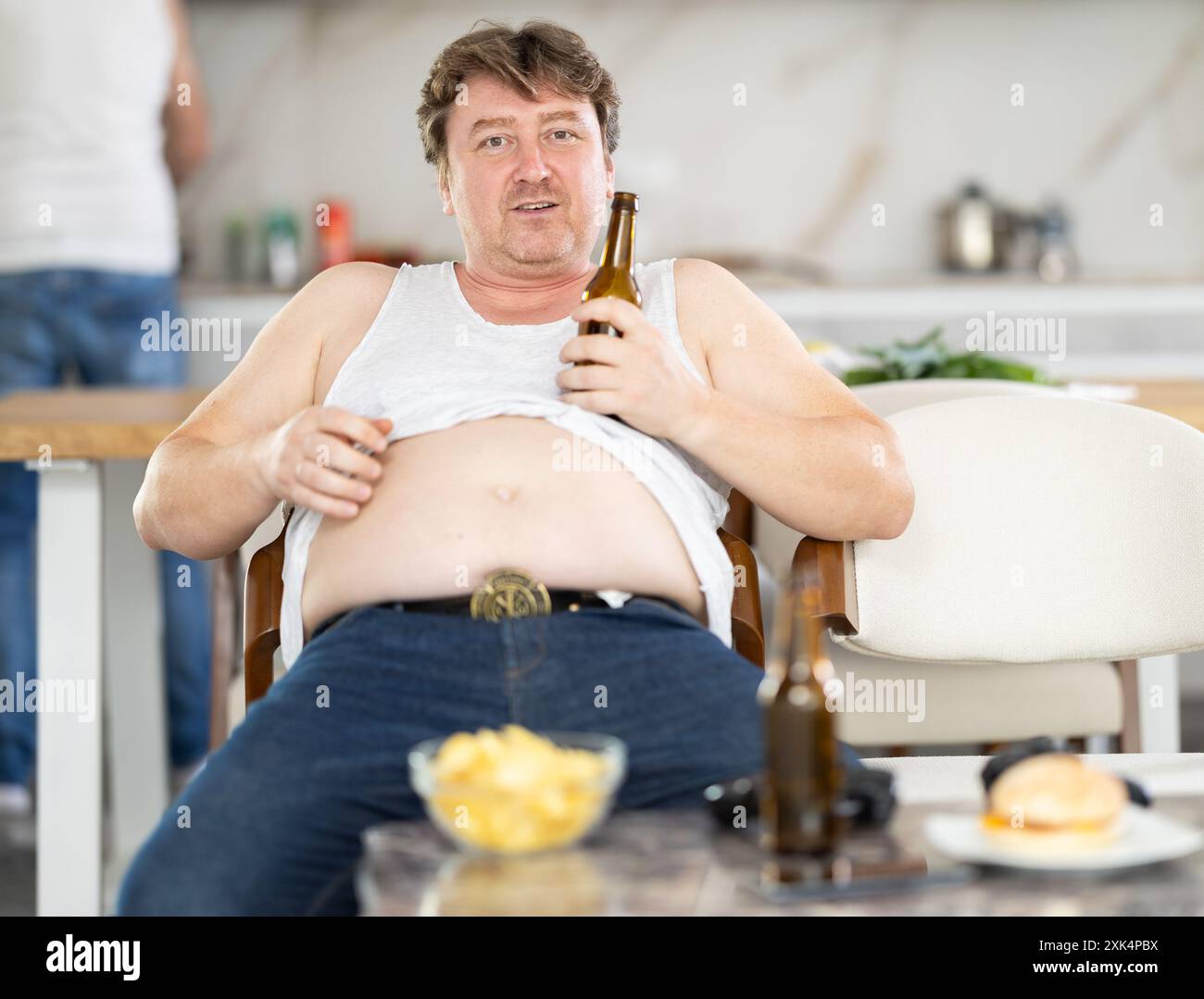 Overweight man with obese belly overeating and drinking beer. Bad ...