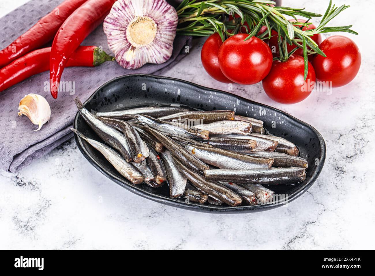 Pickled anchovy fish in the plate Stock Photo - Alamy